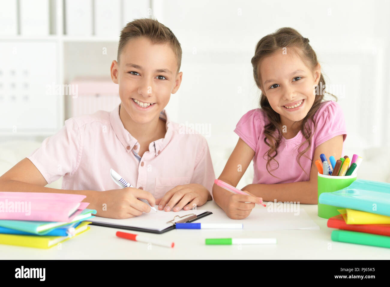 Portrait of brother and sister doing homework Stock Photo - Alamy