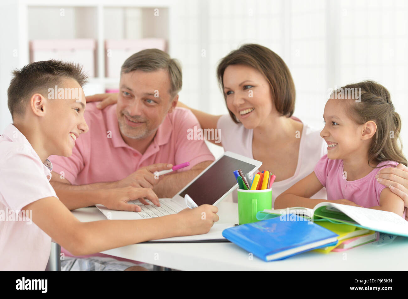 Portrait of big happy family doing homework Stock Photo - Alamy