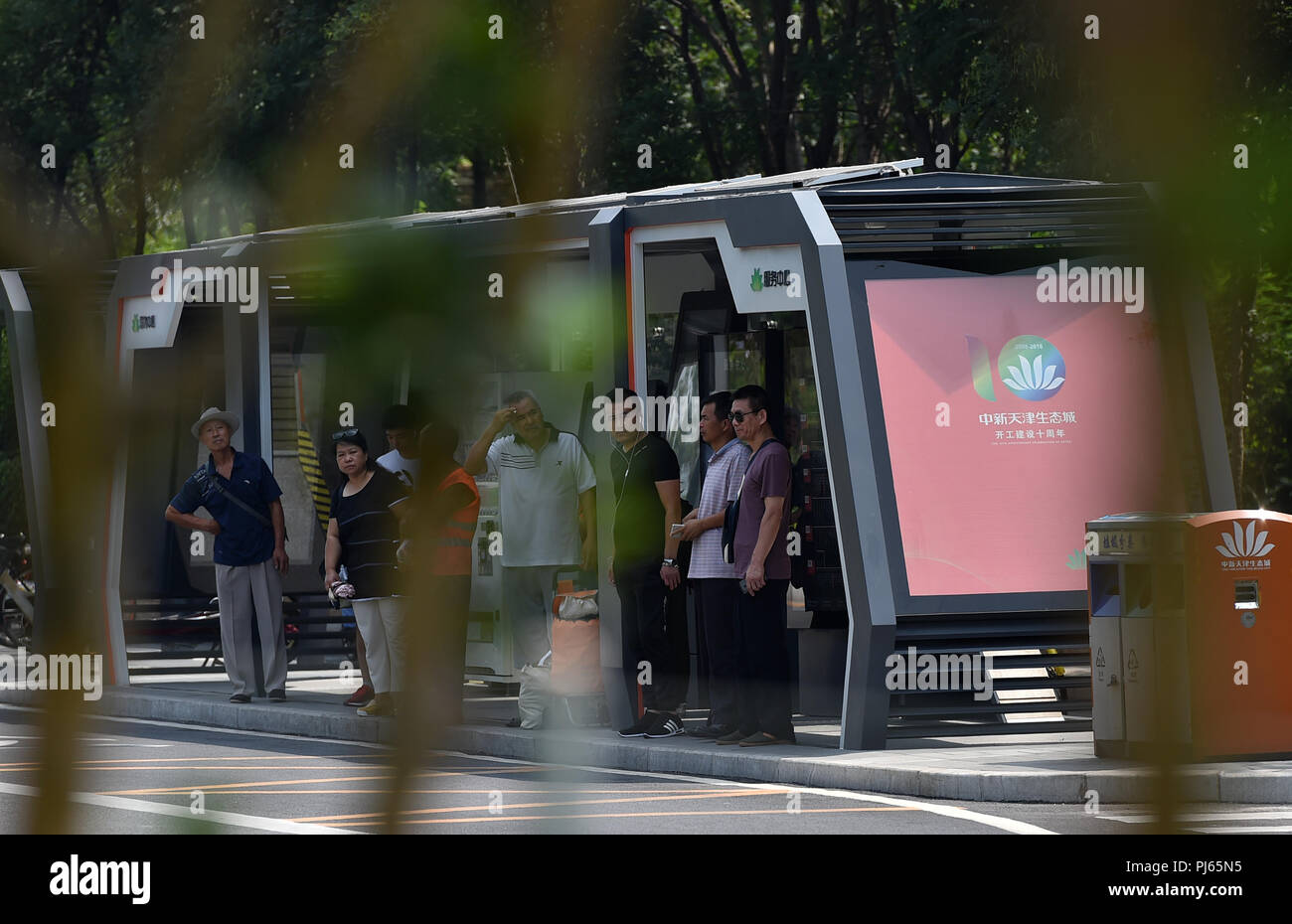 Tianjin, China's Tianjin. 31st July, 2108. Citizens wait for bus at a ...