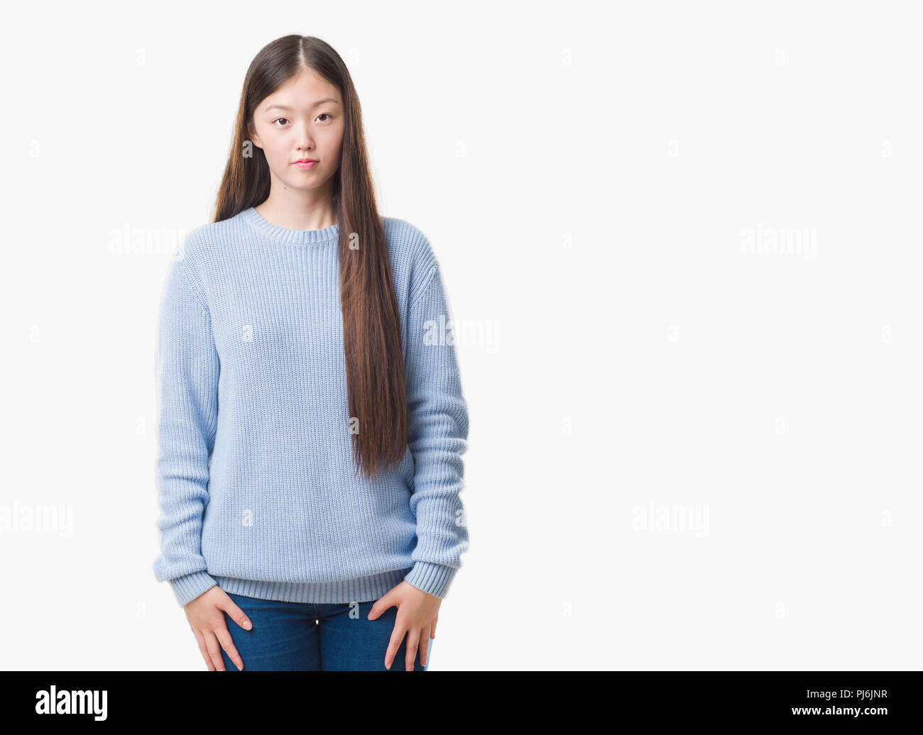 Young Chinese woman over isolated background with serious expression on ...