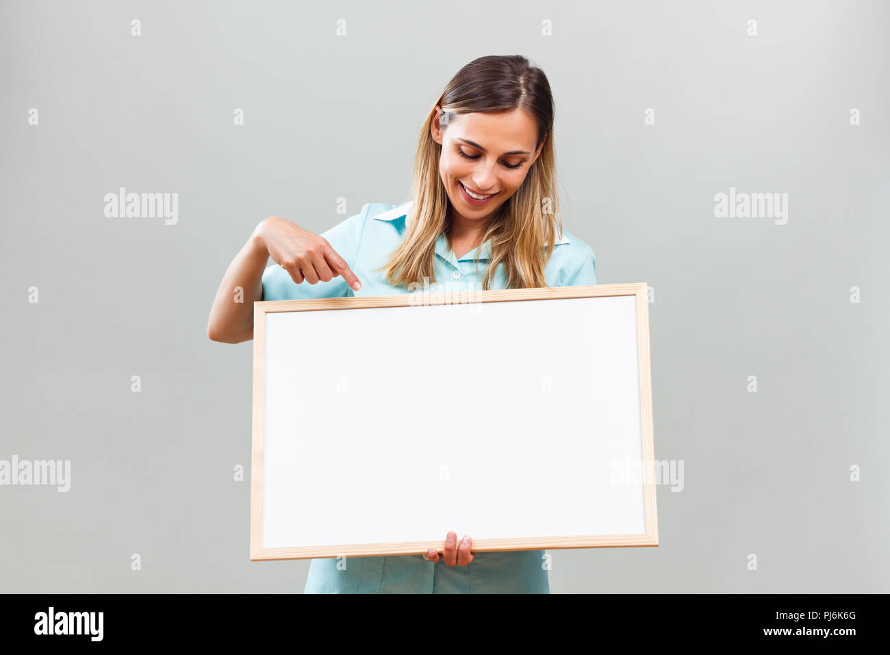Beautiful nurse is pointing at whiteboard Stock Photo - Alamy