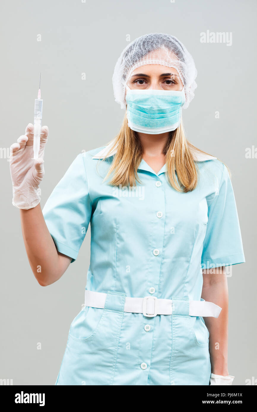 Nurse with protective mask holding injection Stock Photo - Alamy