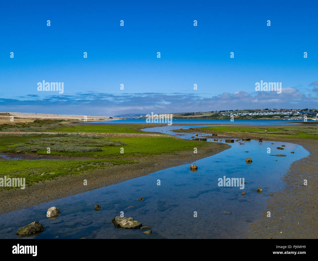 Stream of water leading to Fleet Lagoon at Chesil beach, Dorset ...