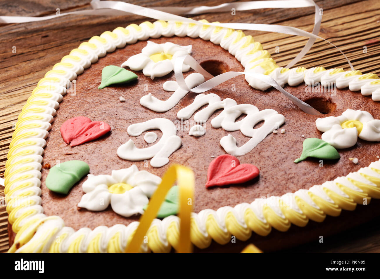 original bavarian Oktoberfest gingerbread heart on wood Stock Photo - Alamy