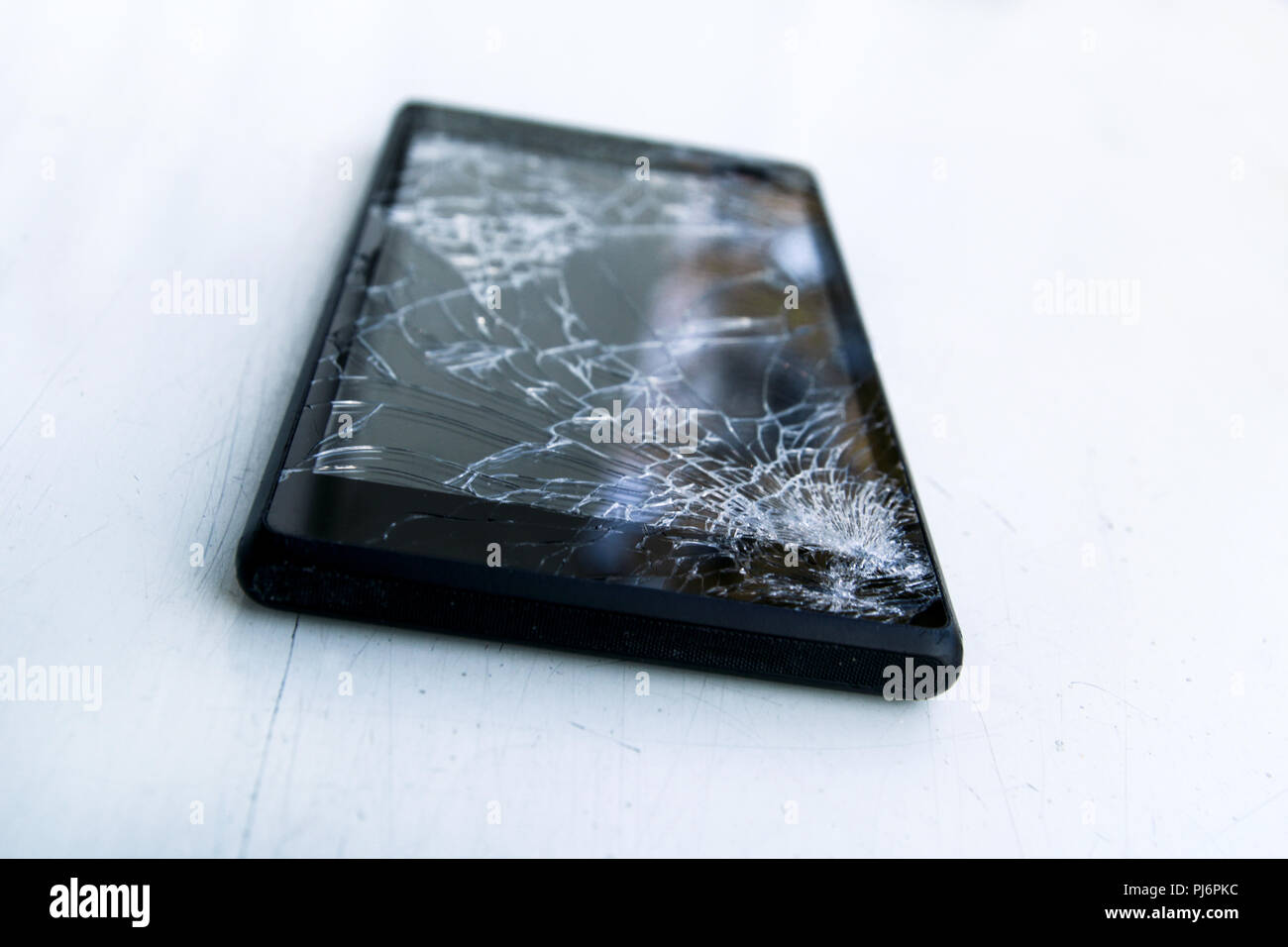 Modern mobile smart phone with broken cracked screen isolated on white ...