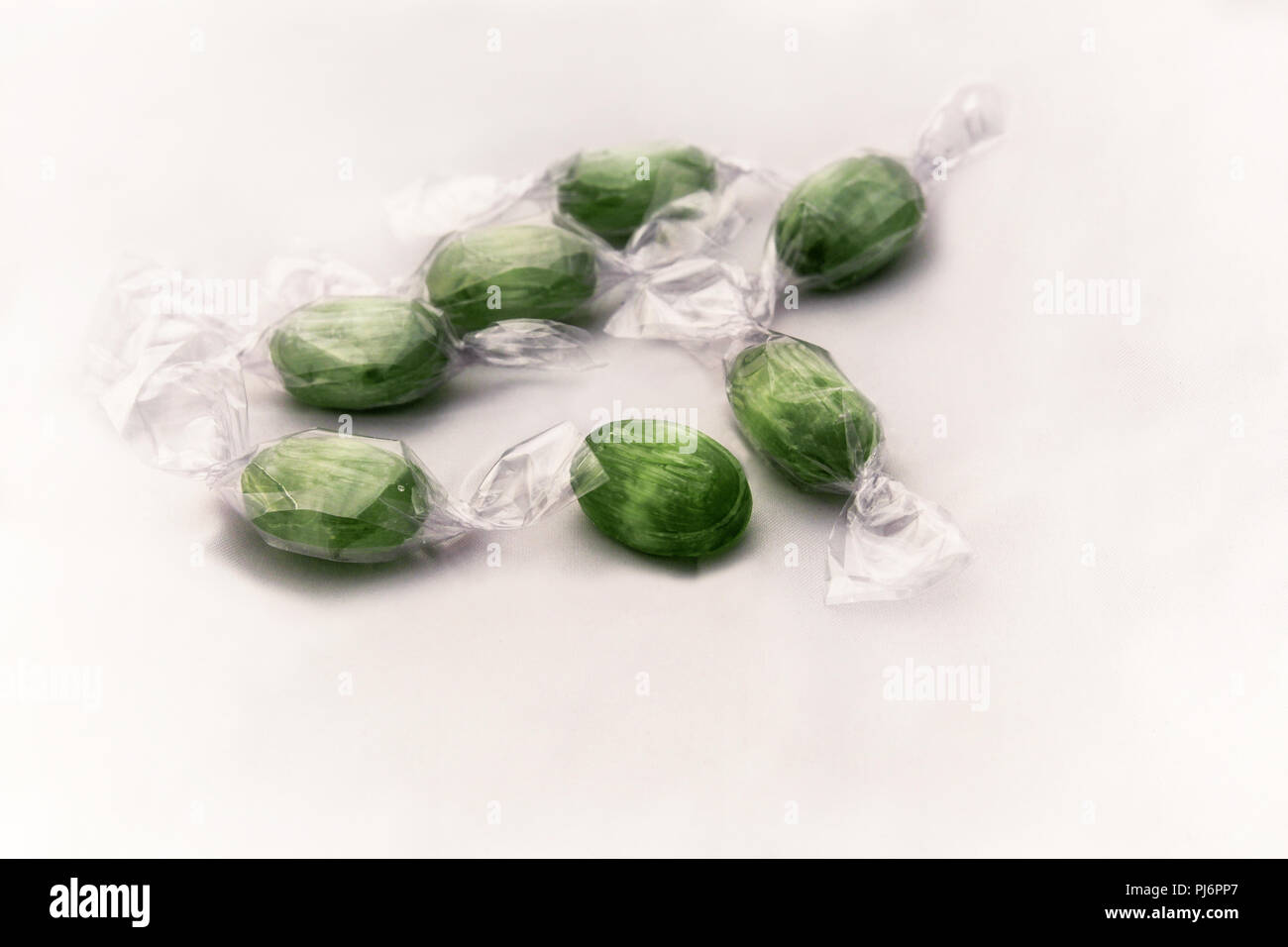 Green sweet candy. Green sweet candy of kiwi in plastic wraps with a ...