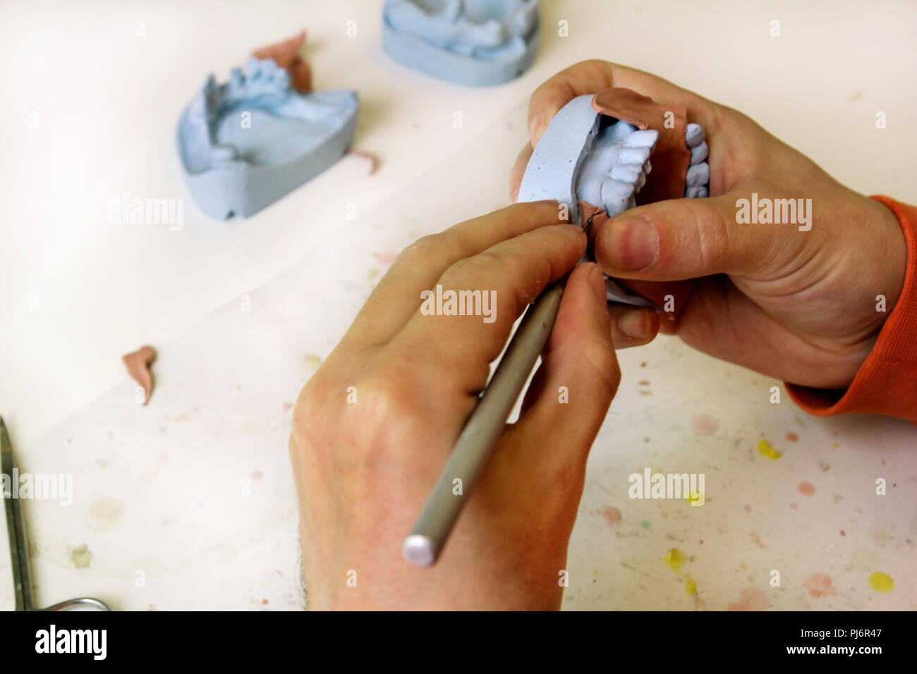 Trimming with scalpel Shellac base plates. Dentures. Dental prosthesis ...