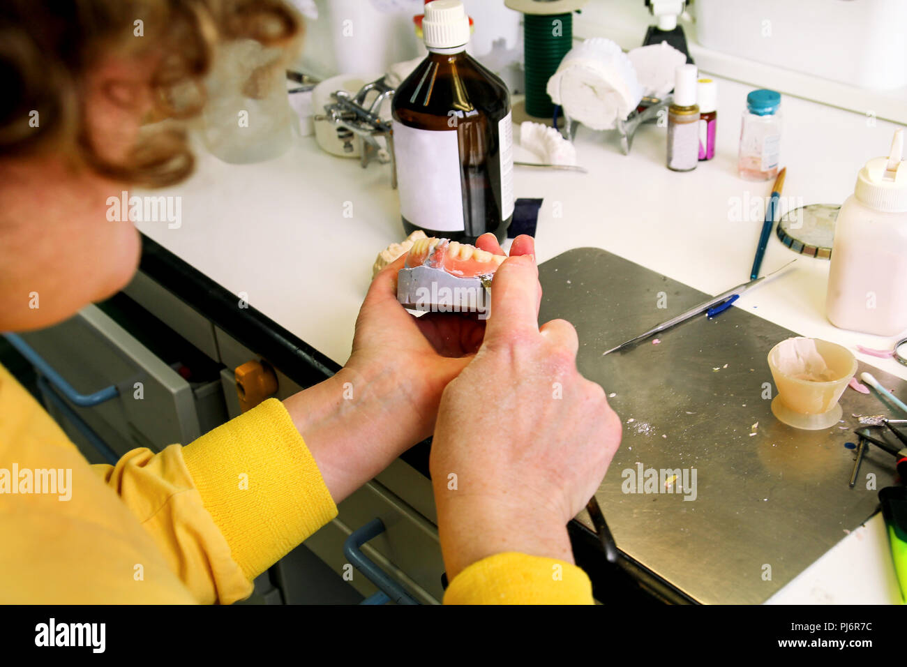 Detaching a dental prosthesis form a plaster model. Dental prosthesis ...