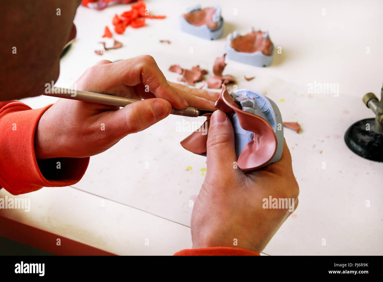 Trimming with scalpel Shellac base plates. Dentures. Dental prosthesis ...