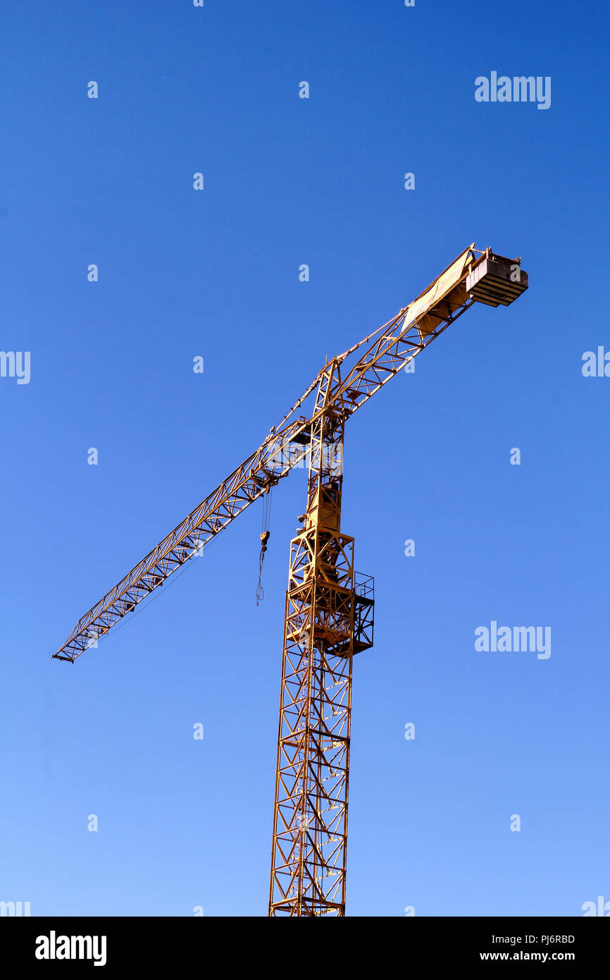 Yellow crane hoist. Yellow crane hoist with blue sky in the background ...