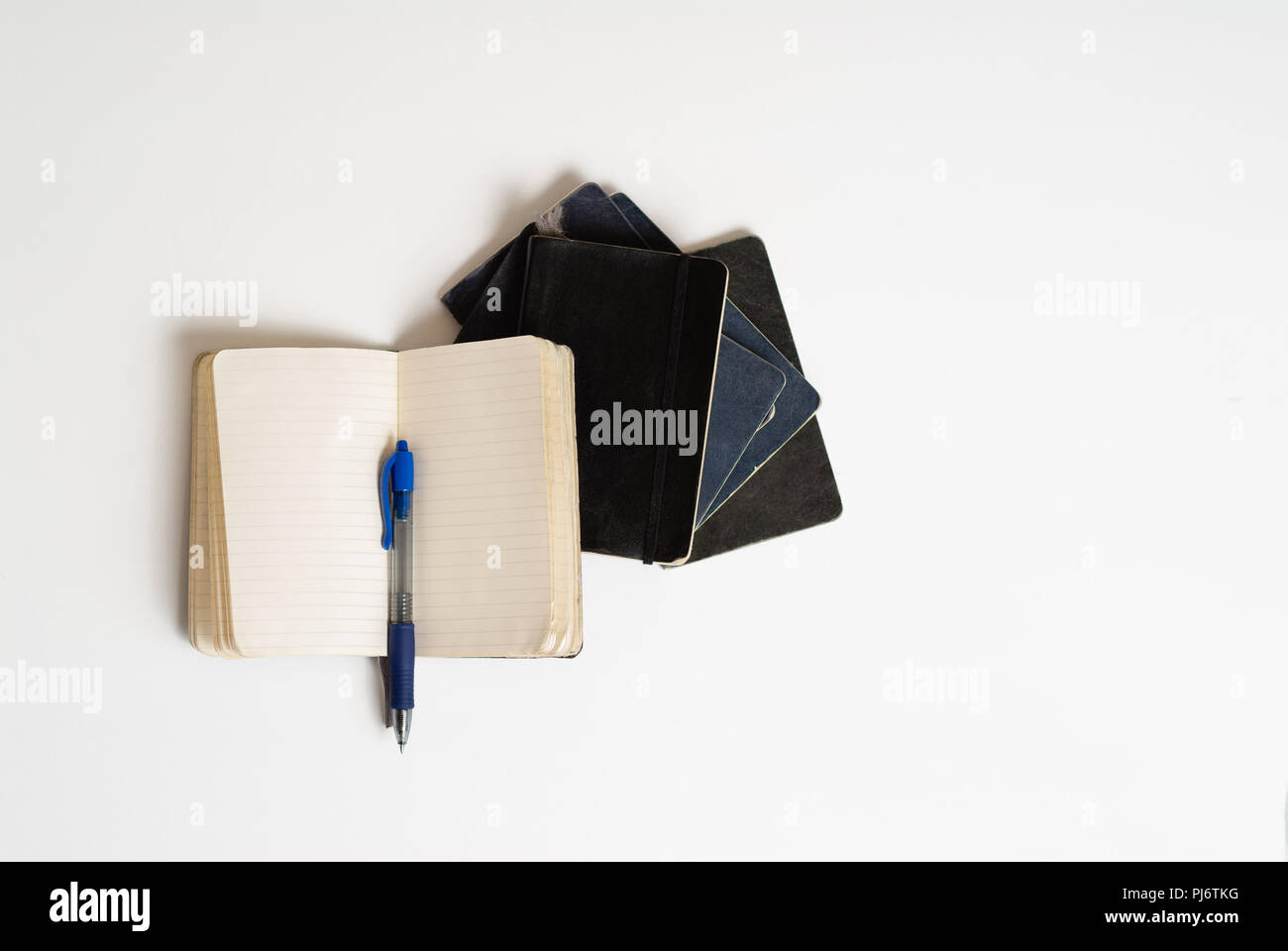 Stacked isolated worn notebook journals with pen Stock Photo - Alamy