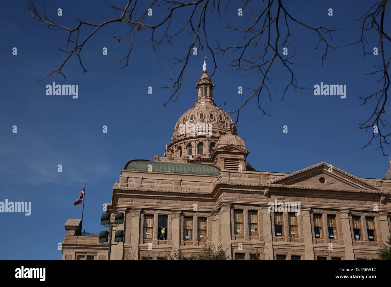 The Texas capitol building and dome with the Texas flag in Austin Texas ...