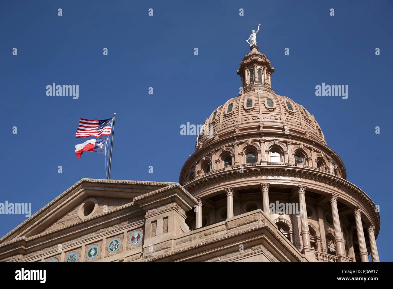 The Texas capitol building and dome with the Texas flag in Austin Texas ...