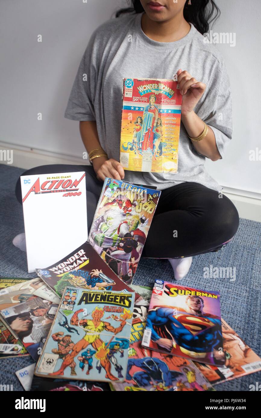 black girl reading wonder woman comic books Stock Photo - Alamy