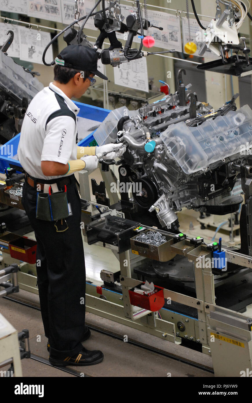 A worker assembles an engine of a Toyota Motor Corp. top-of-the-range ...