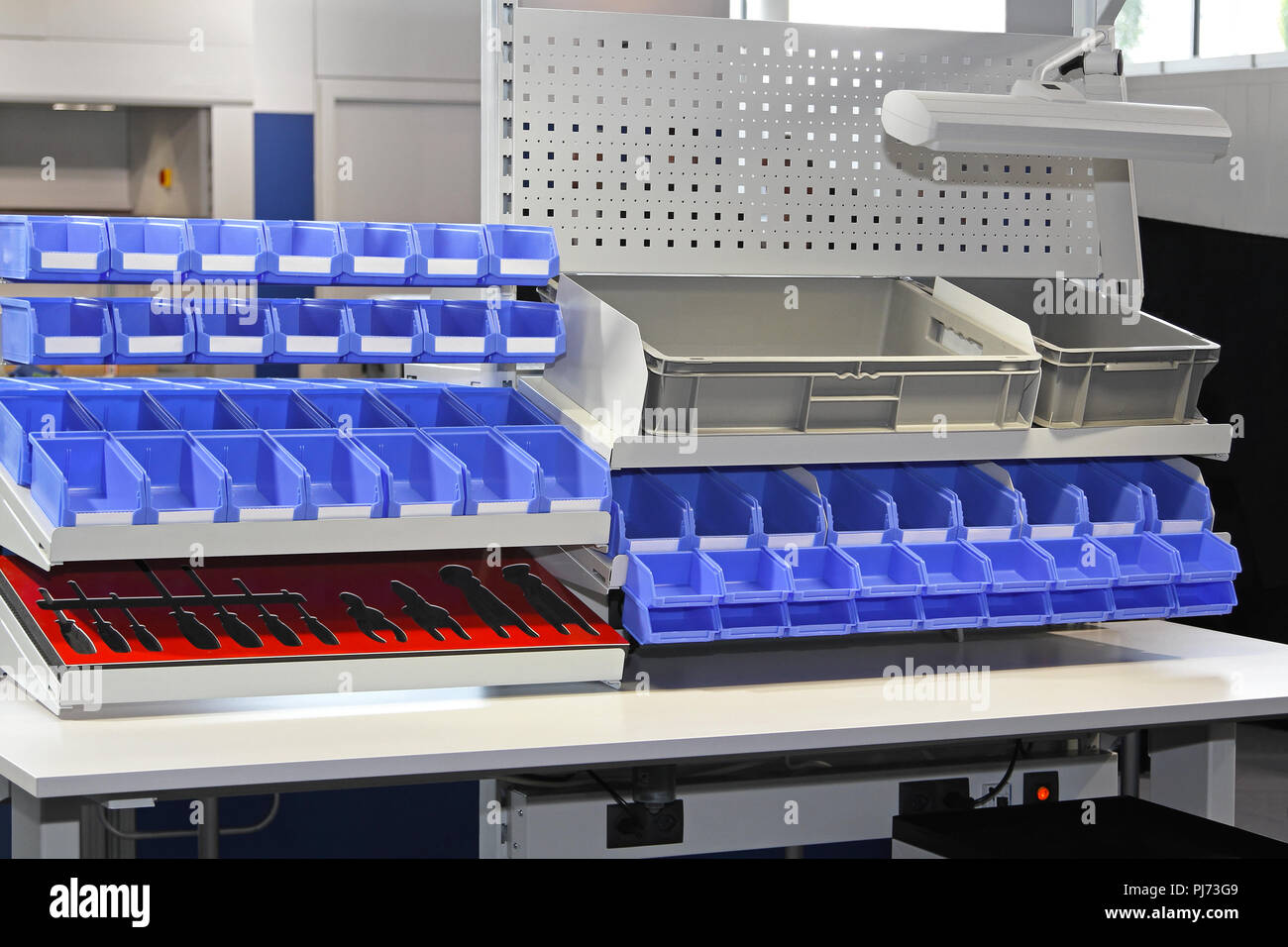 Modular working desk with plastic sorting bins Stock Photo - Alamy