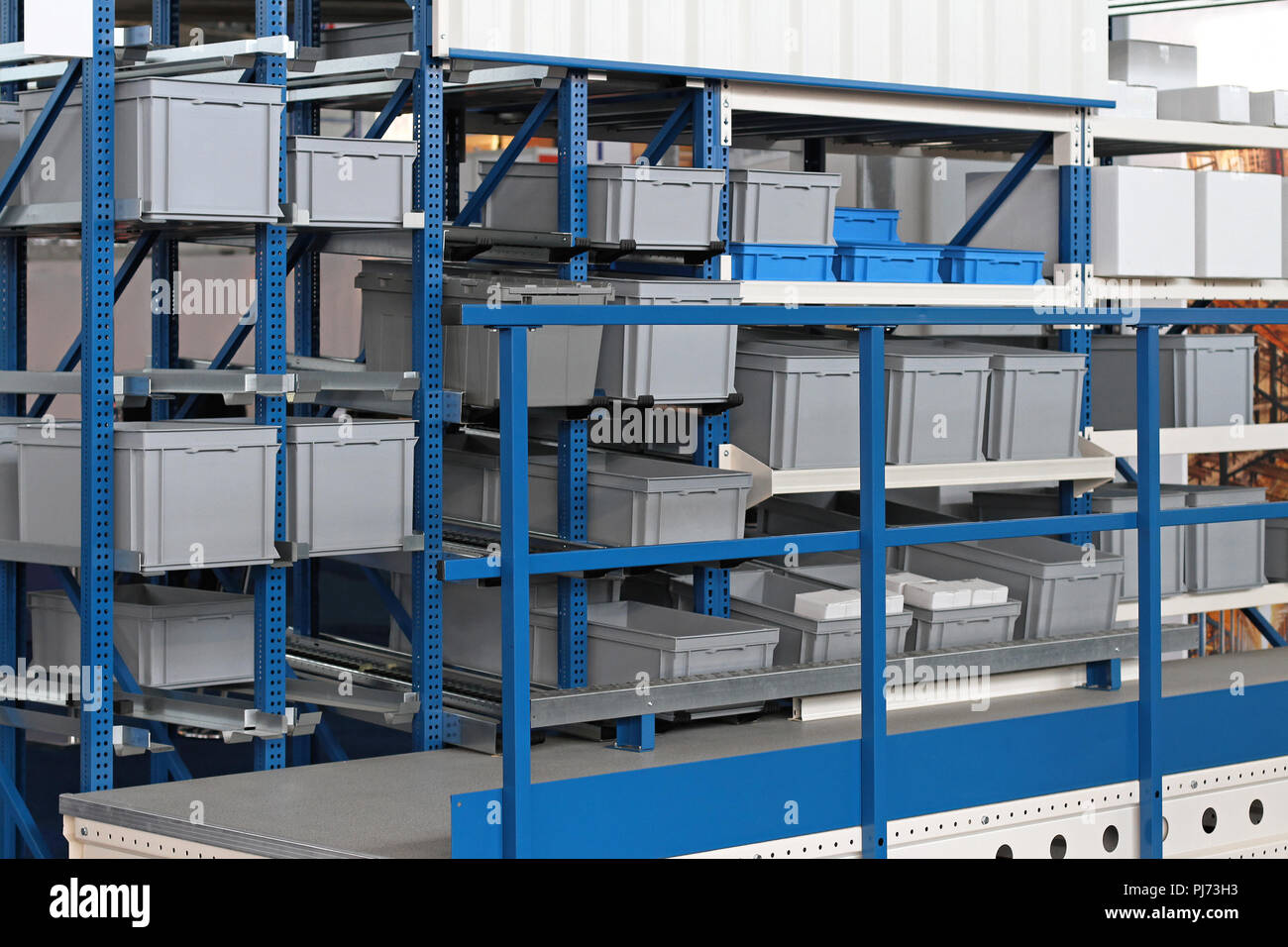 Plastic boxes and crates in storage room shelf Stock Photo - Alamy