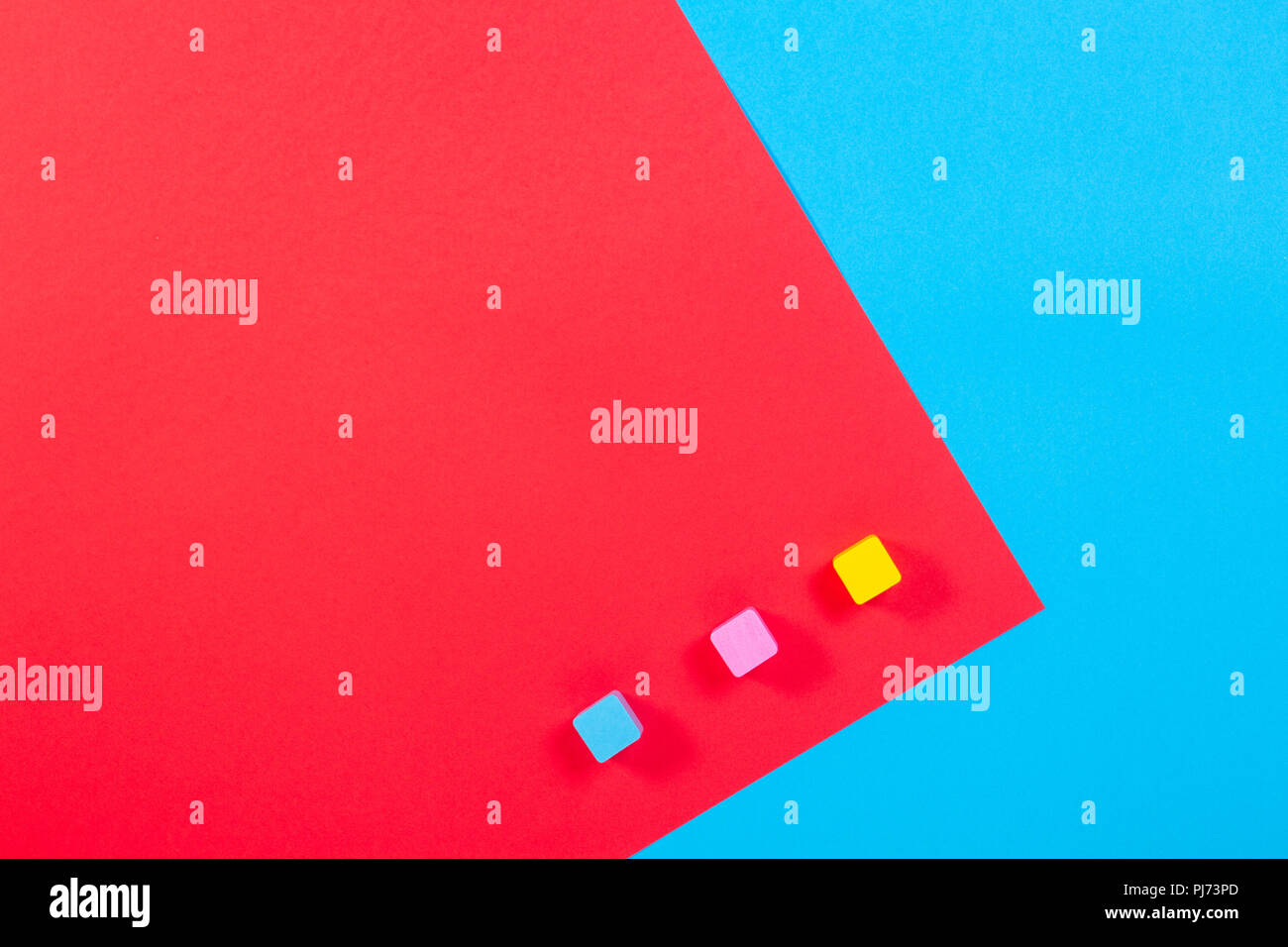 Colorful wooden blocks on blue and red background Stock Photo - Alamy