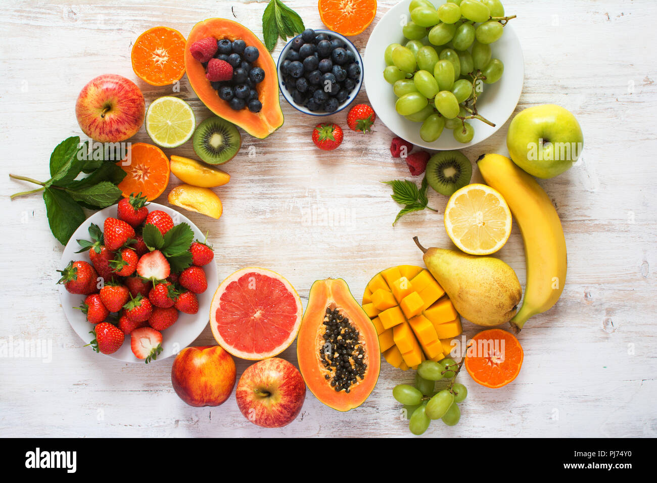 Rainbow color fruits arranged in a circle, strawberries, blueberries ...