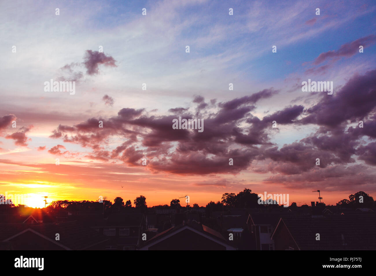 Sunset captured over village Stock Photo - Alamy