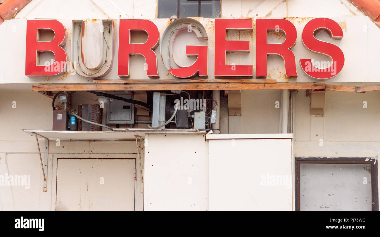 Retro red burger sign from the 60s in disrepair, rusty gray electrical ...