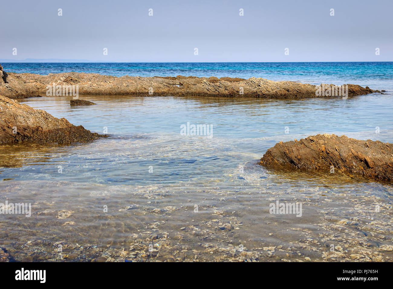 Calm translucent turquoise sea, beautiful rocky reef and underwater sea ...