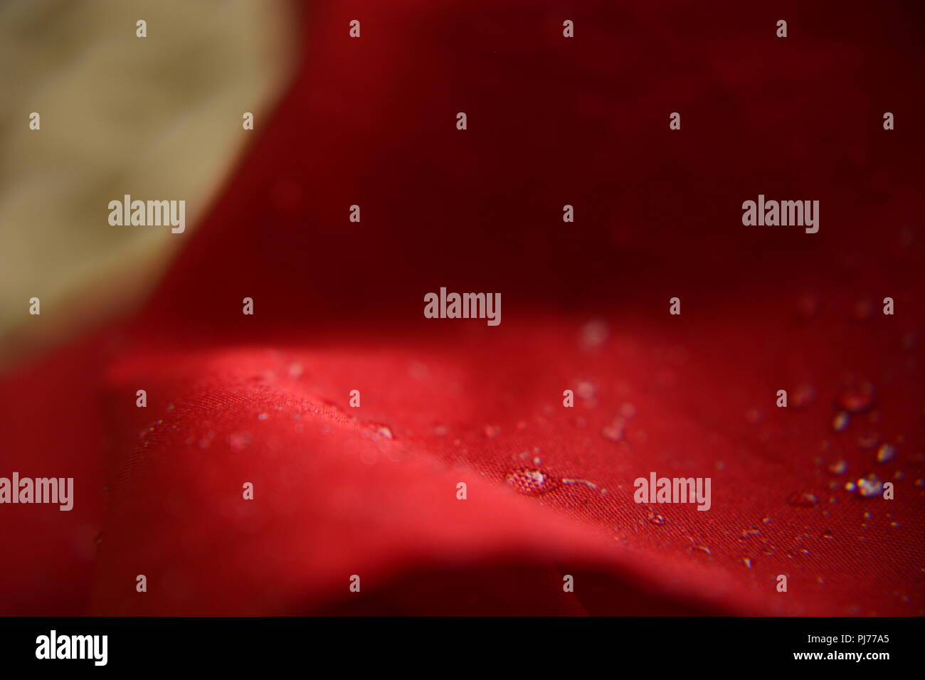 water drops on red fabric Stock Photo - Alamy