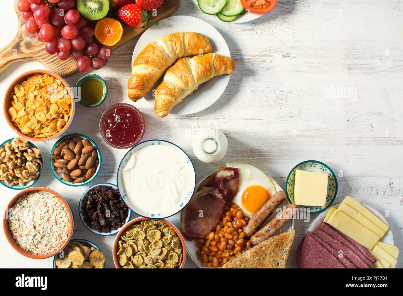 Top view of the healthy filling breakfast, eggs, sausages, bacon, beans ...