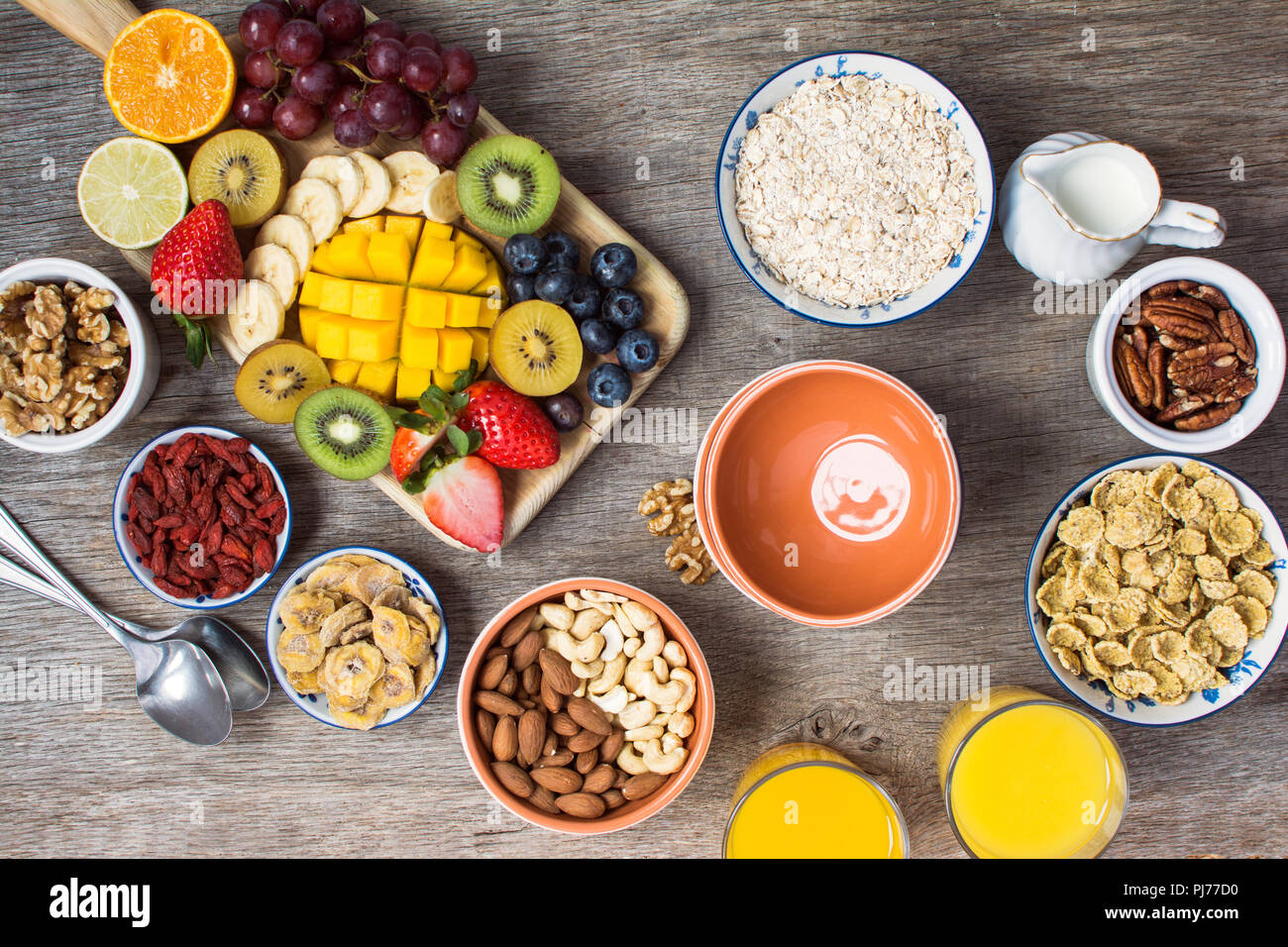 Healthy and various morning breakfast selection: cereals, nuts, orange ...
