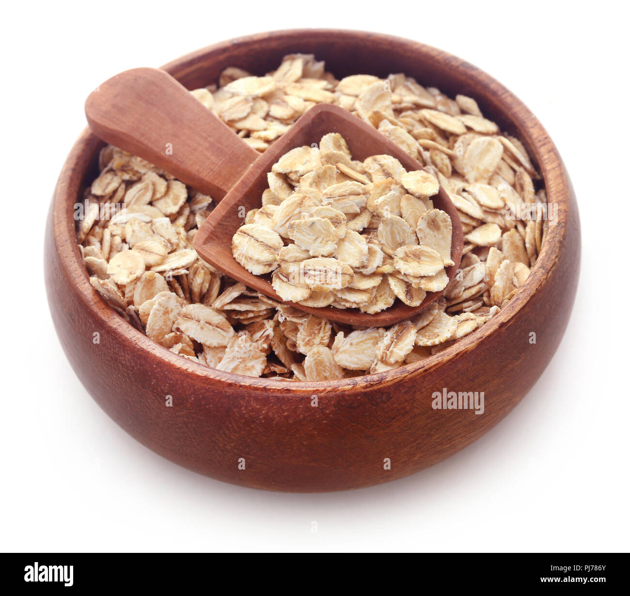Whole oats in a bowl isolated over white background Stock Photo - Alamy