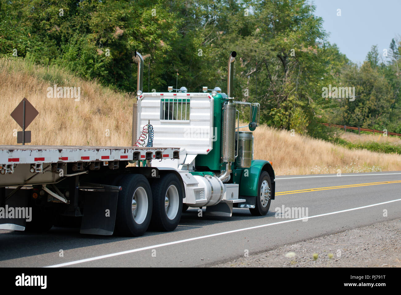 Professional big rig day cab semi trucks with flat trailers are popular ...