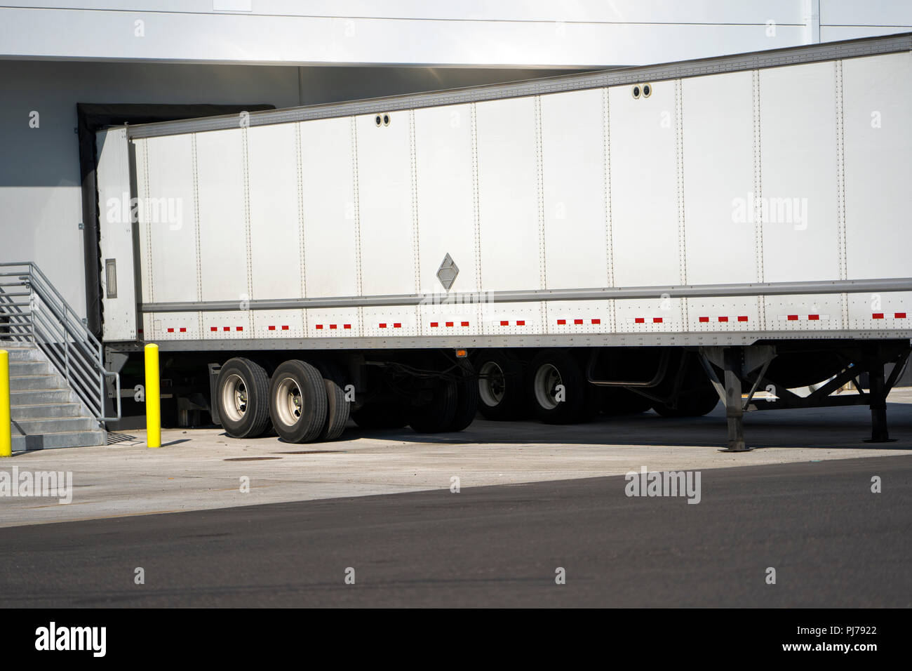 Huge number of big and small rig semi trucks are loaded and unloaded in ...