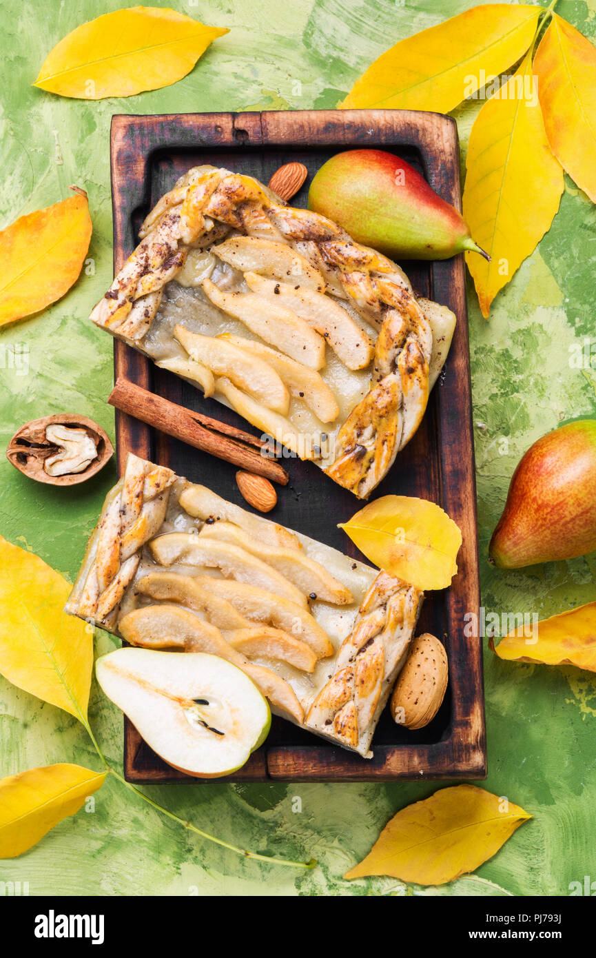 Rustic pie with pears and fallen autumn foliage. Autumn kitchen Stock ...