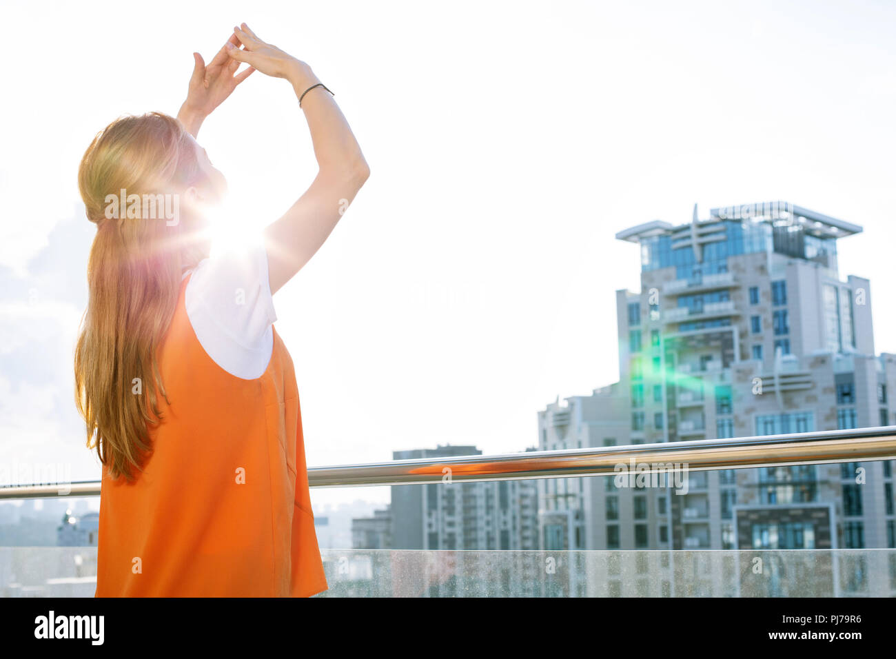 Beautiful nice woman holding her hands up Stock Photo - Alamy