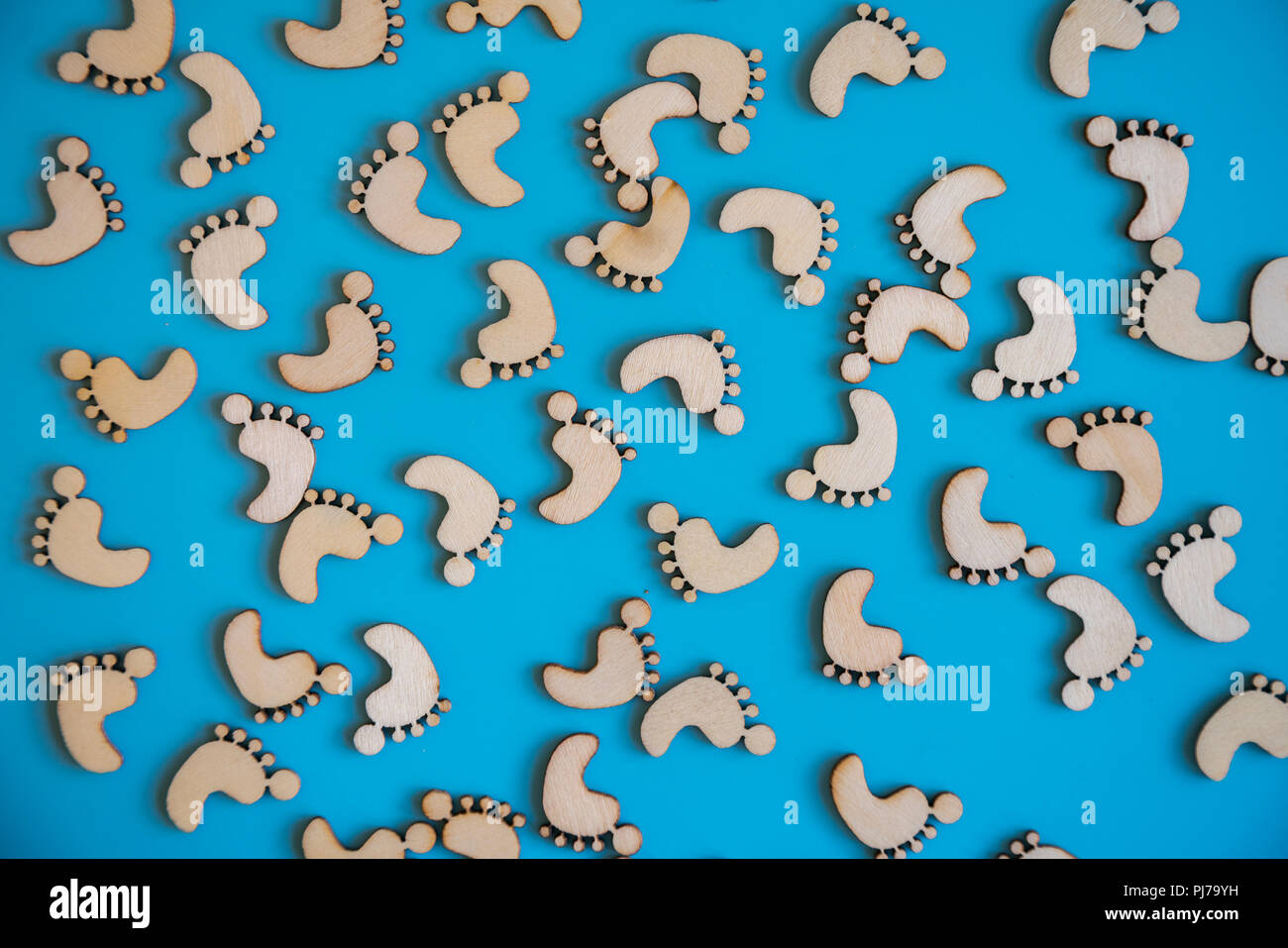 Footprints on a blue background. Wooden traces are scattered on a blue ...