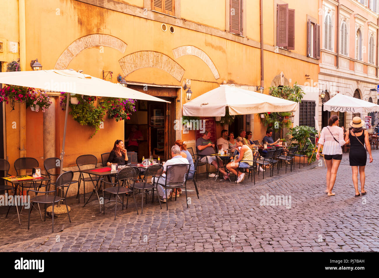 Tourists seated outside a typical bar in the Trastevere district, Lazio ...