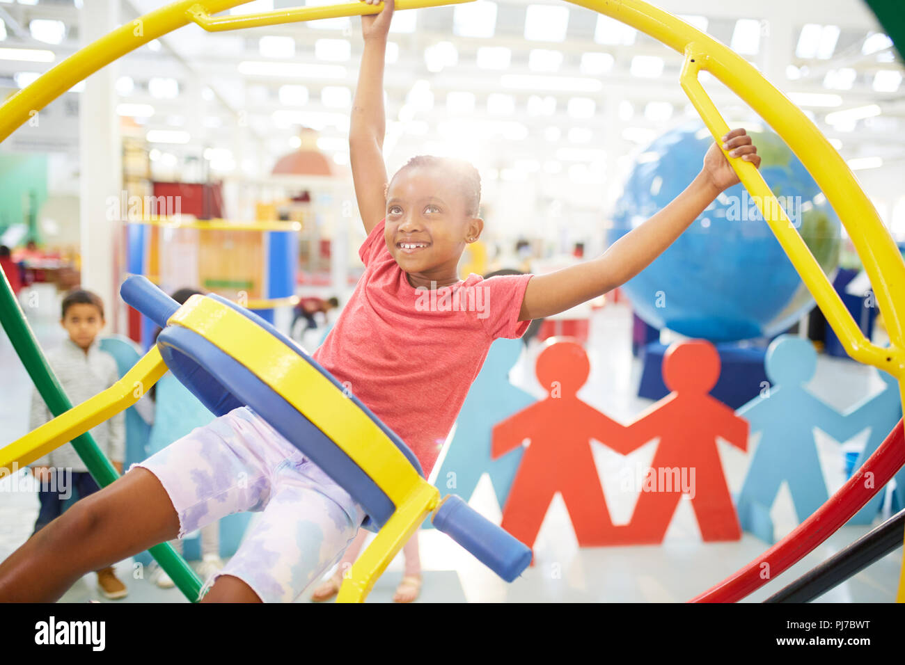 Girl using gyroscope in science center Stock Photo - Alamy