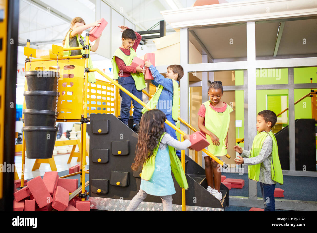 Kids playing, stacking bricks at interactive construction exhibit in ...