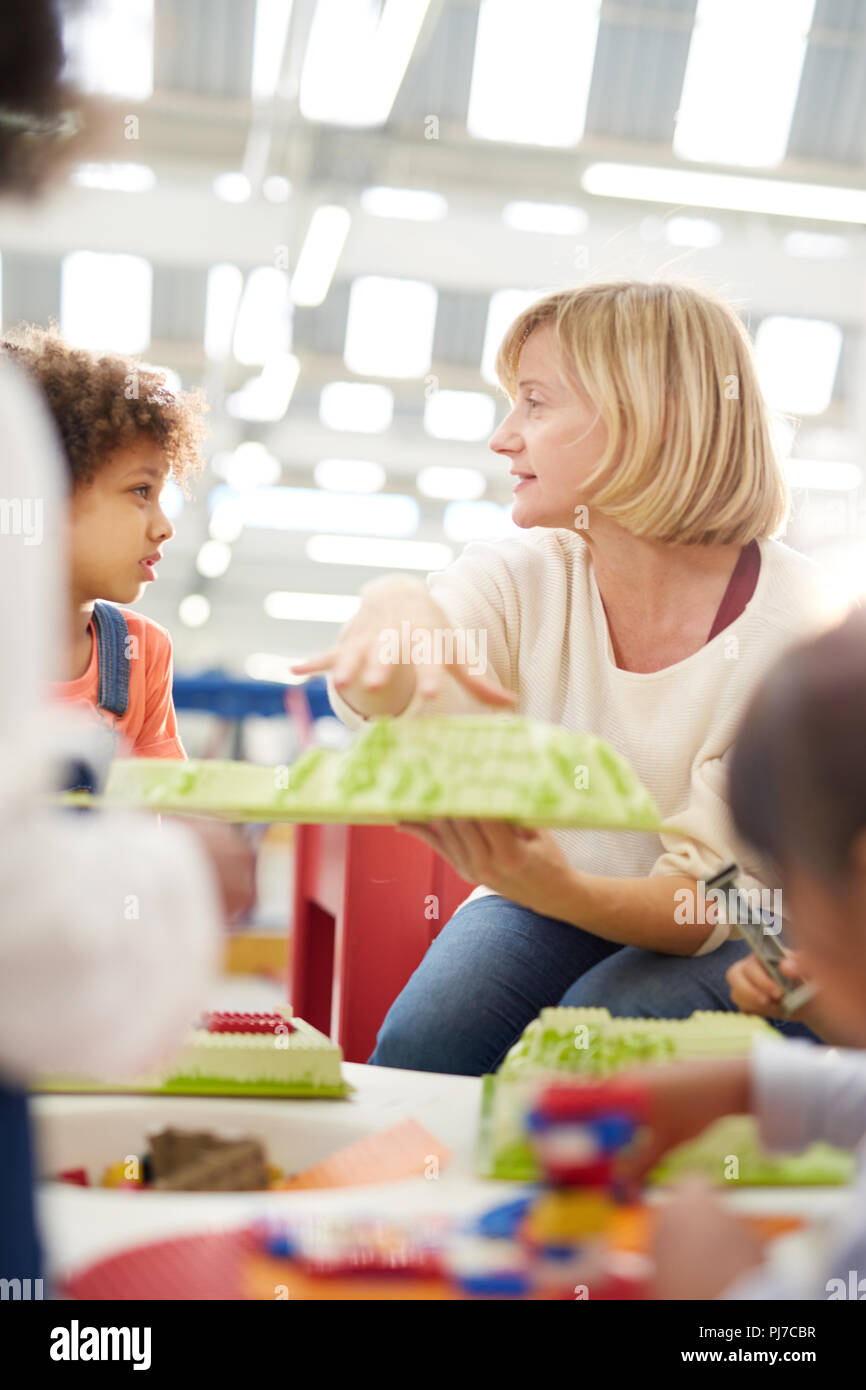 Teacher and students at interactive exhibit in science center Stock ...