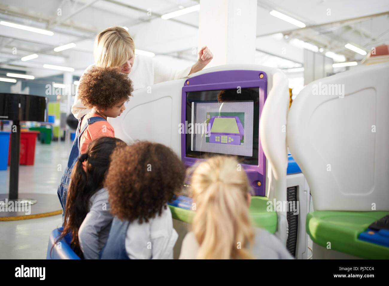 Teacher and students at interactive exhibit in science center Stock ...