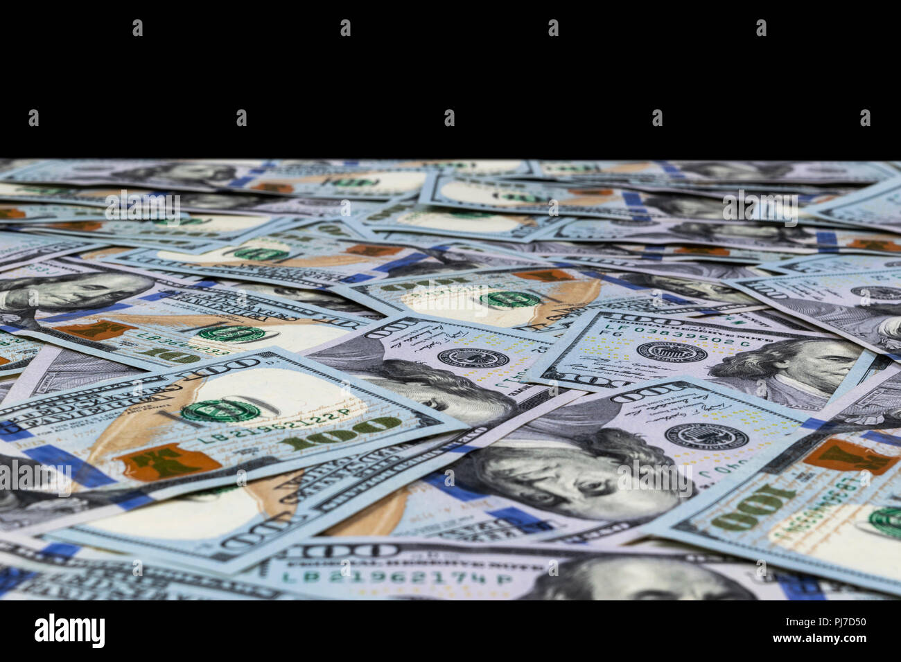 Stack of one hundred dollar bills isolated on black background. Stack ...