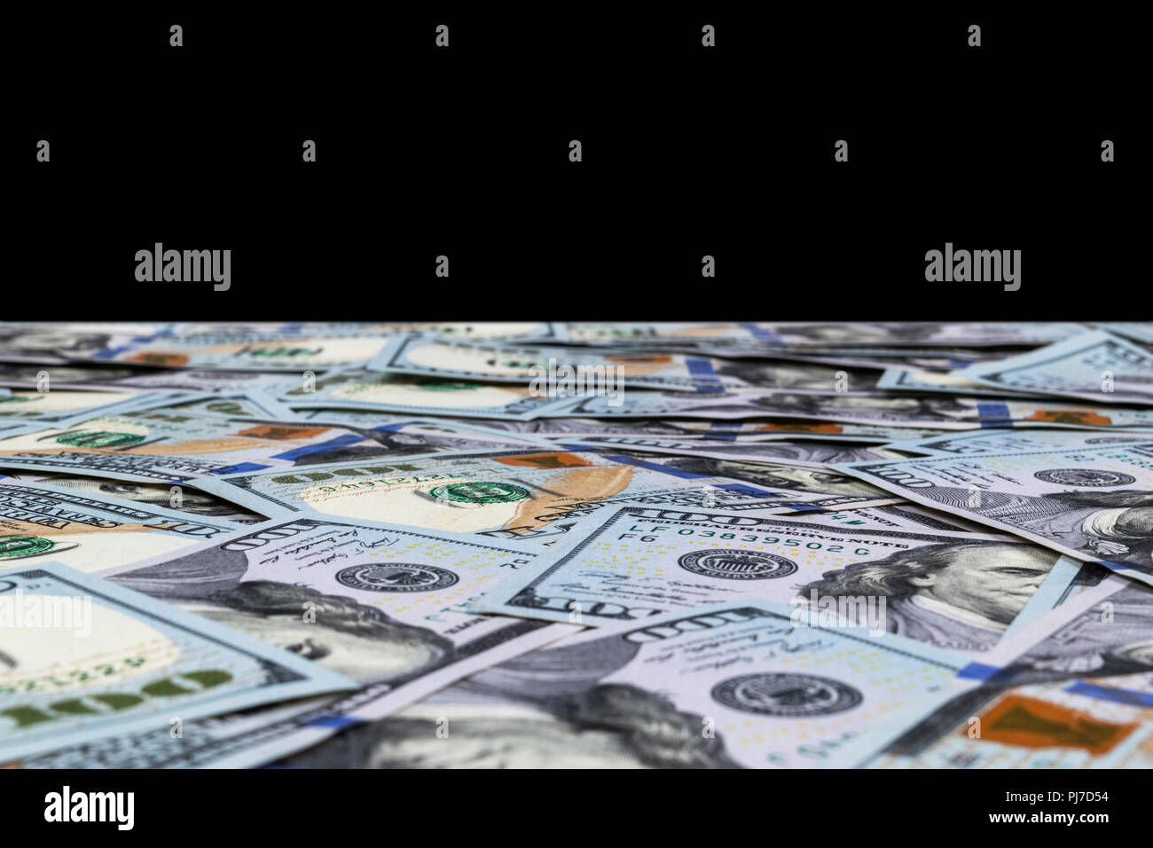 Stack of one hundred dollar bills isolated on black background. Stack ...