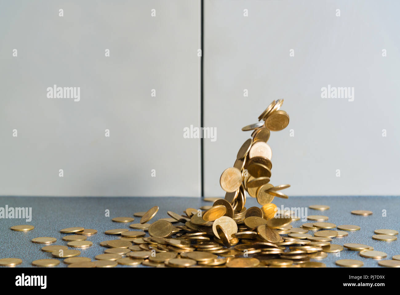 Falling gold coins money on office table with document cabinet ...