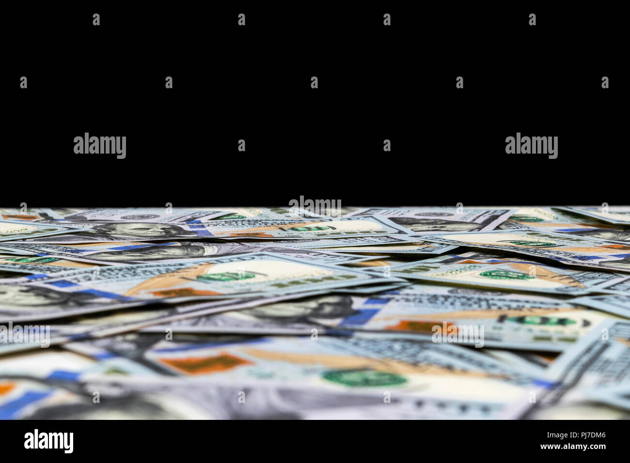 Stack of one hundred dollar bills isolated on black background. Stack ...
