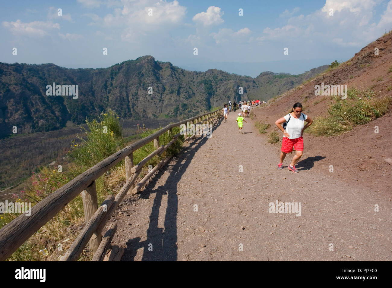 MOUNT VESUVIUS, ITALY - AUGUST 1, 2018: Tourists walk around the crater ...