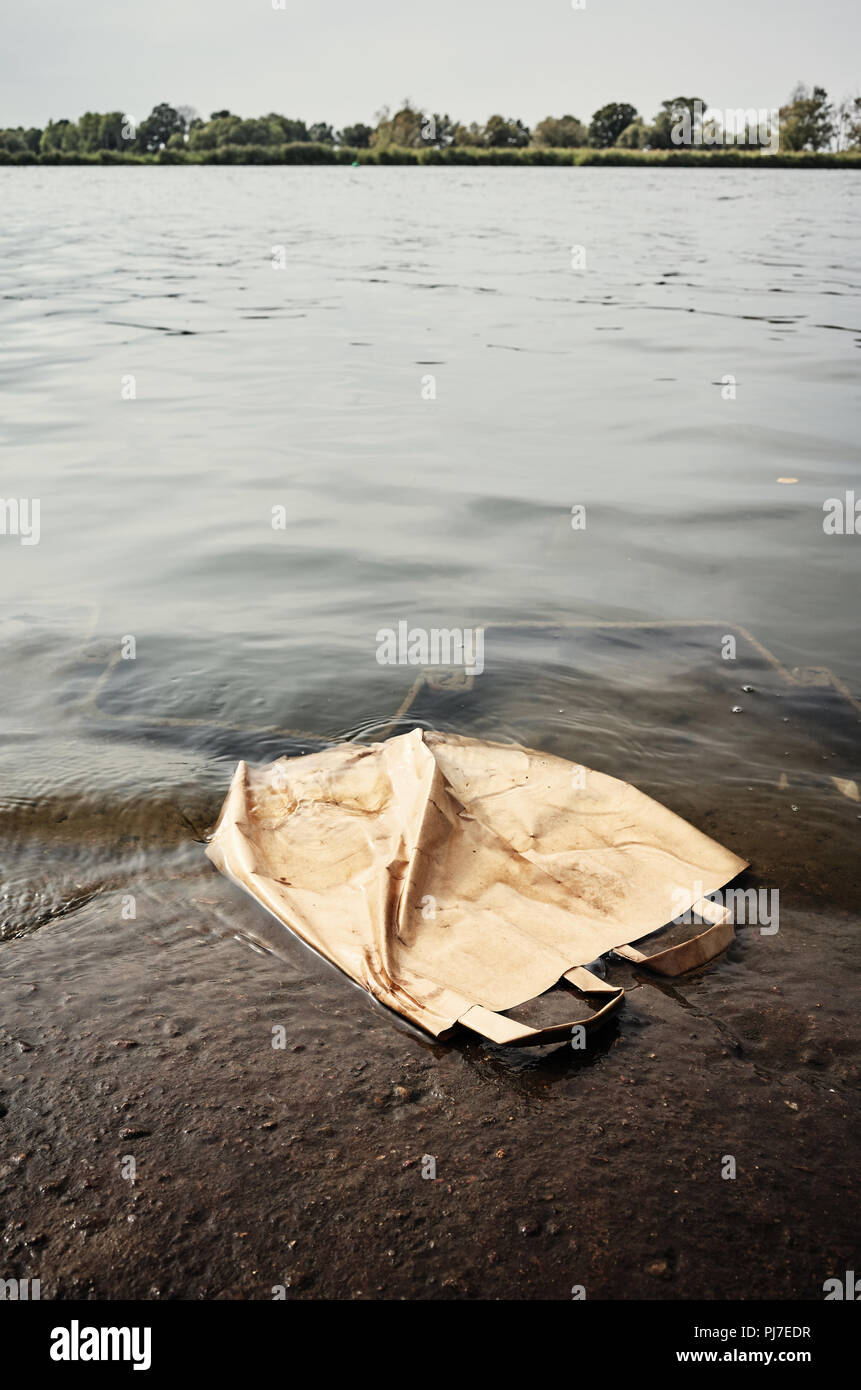 Paper shopping bag in water, conceptual picture Stock Photo - Alamy