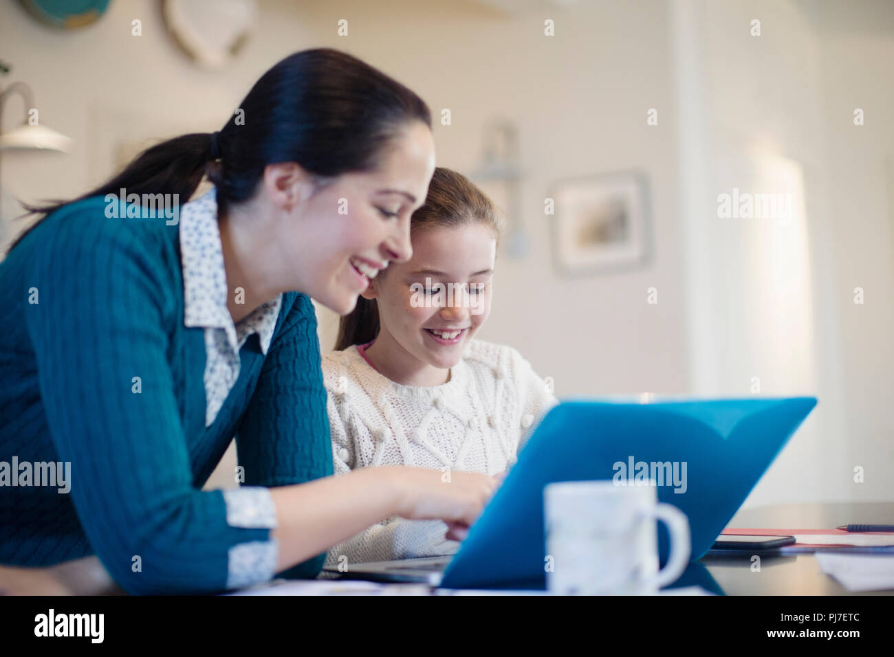 Happy family sitting laptop hi-res stock photography and images - Alamy