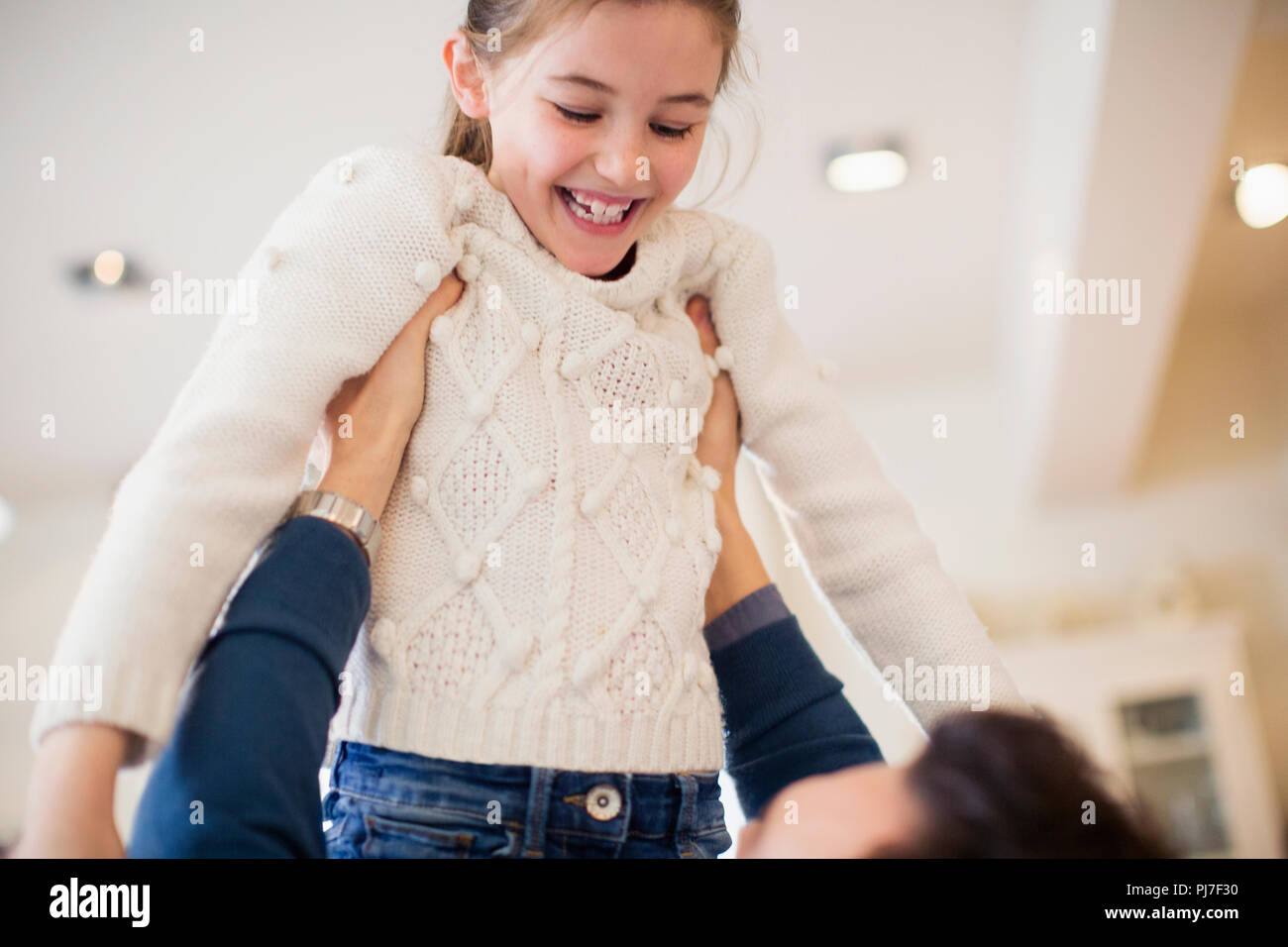 Playful father lifting daughter Stock Photo - Alamy