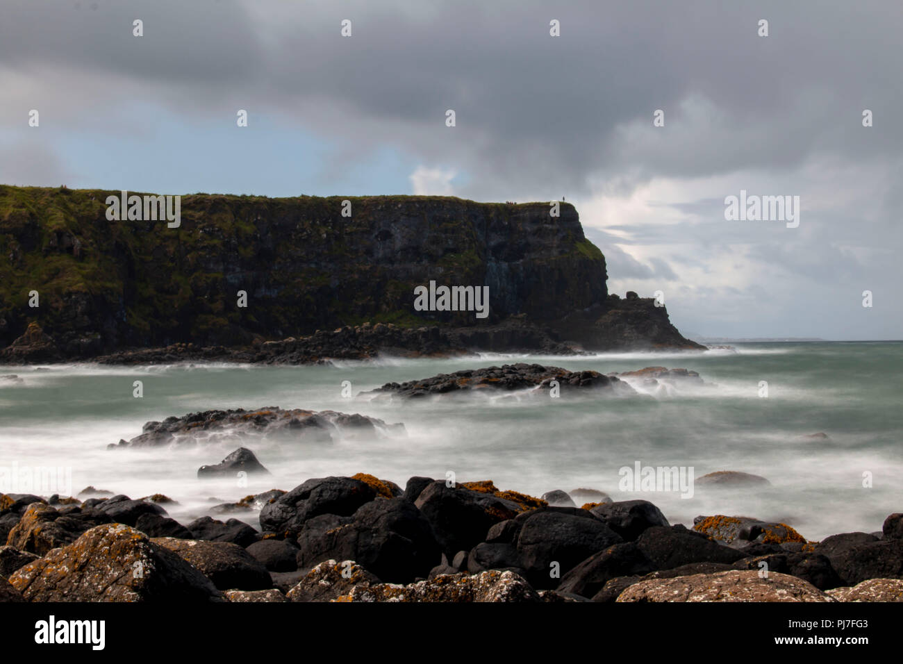 Floating rocks infront of a cliff Stock Photo - Alamy