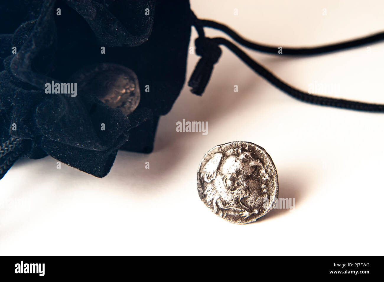 Ancient greek coin isolated on white background Stock Photo - Alamy